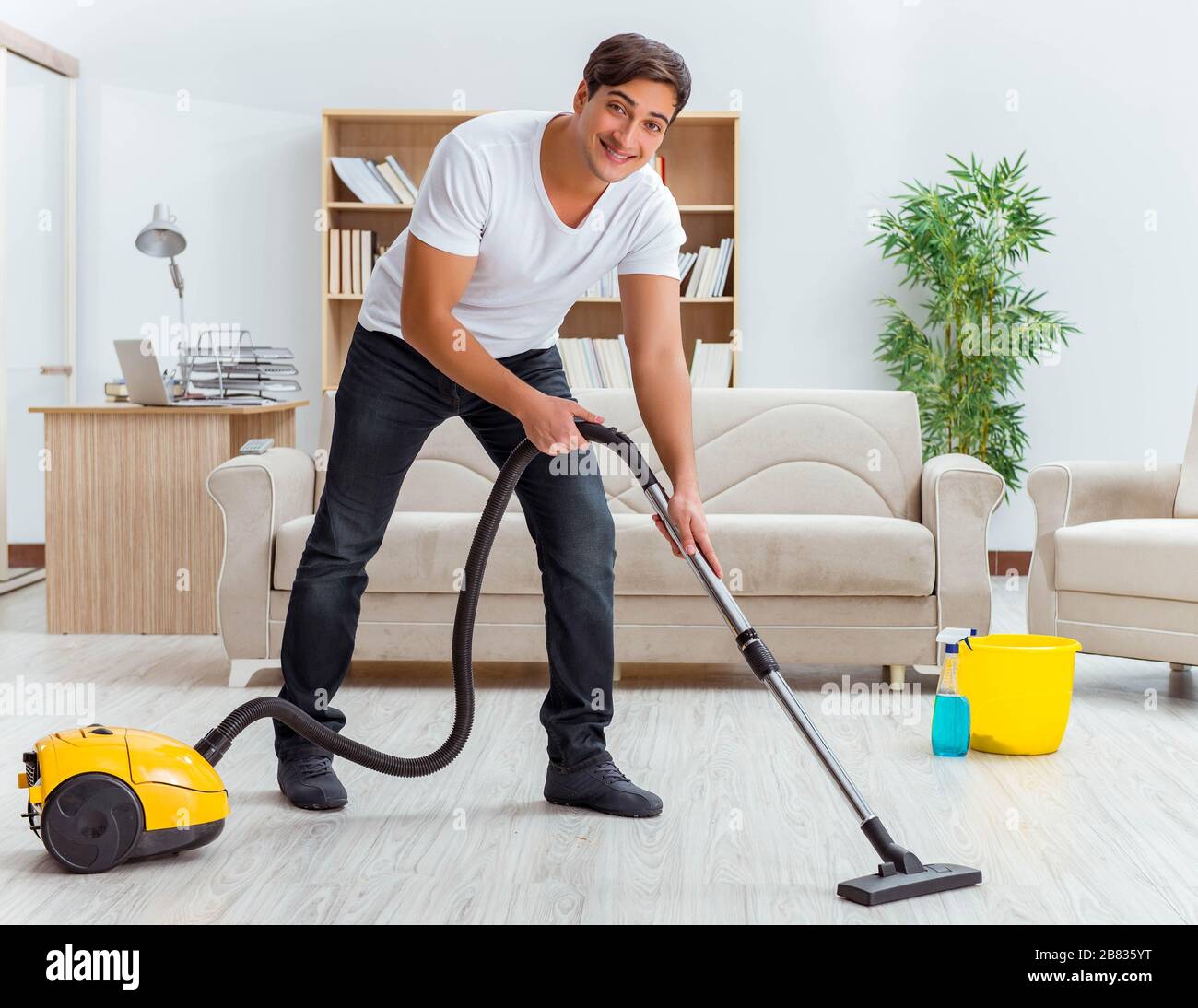 The man husband cleaning the house helping wife Stock Photo - Alamy