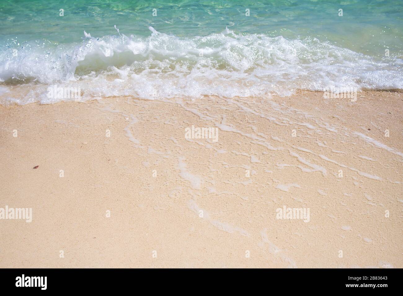 Soft blue ocean wave on clean sandy beach. The blue sea soft wave on ...