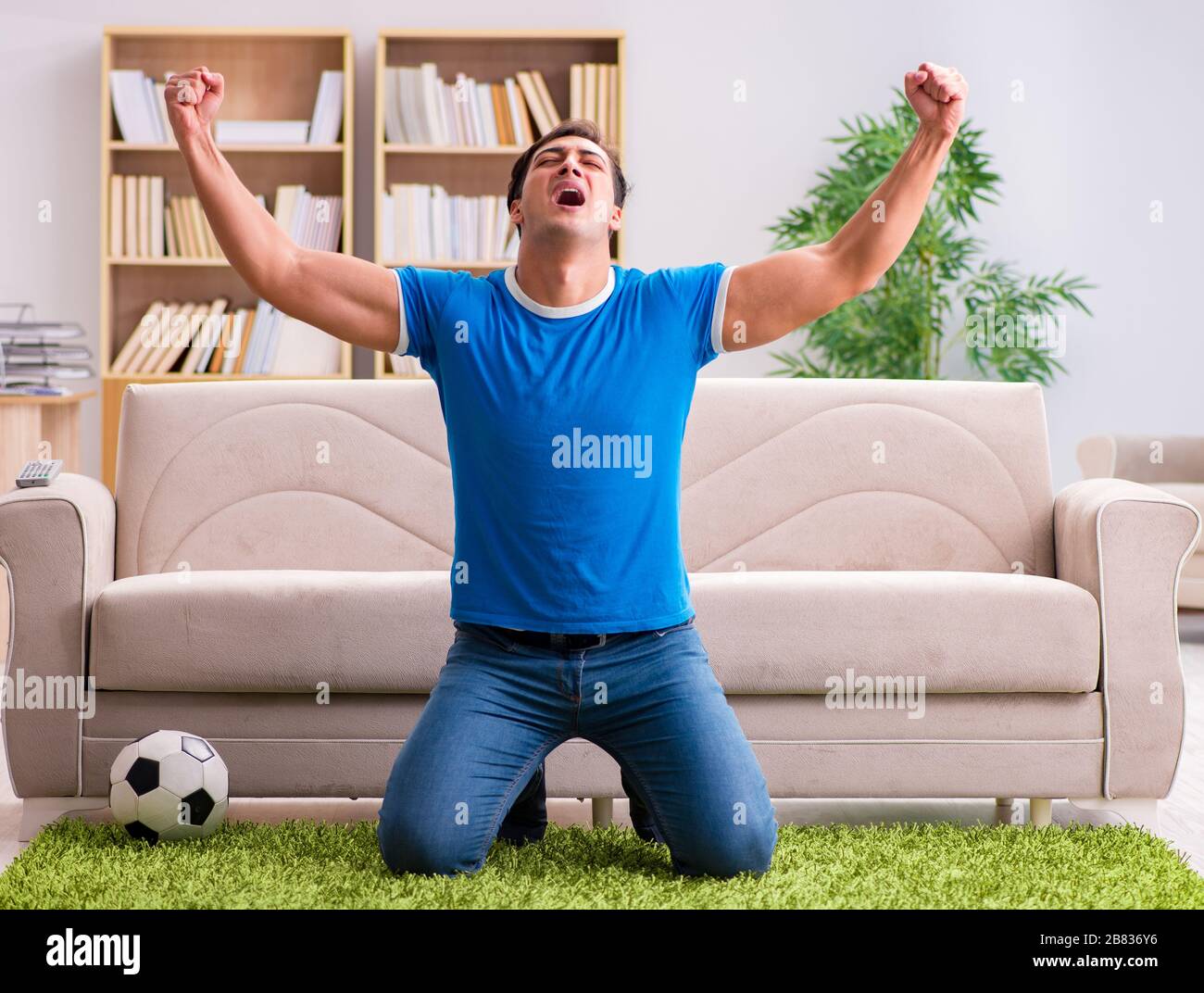 The man watching football at home sitting in couch Stock Photo - Alamy