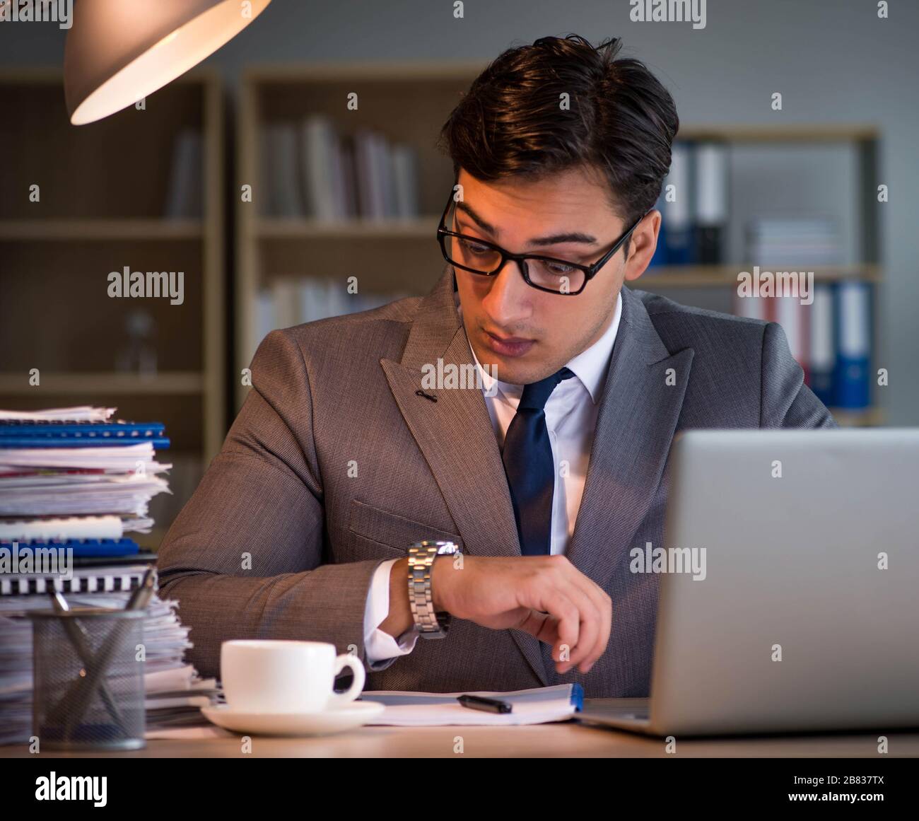 The businessman staying in the office for long hours Stock Photo - Alamy