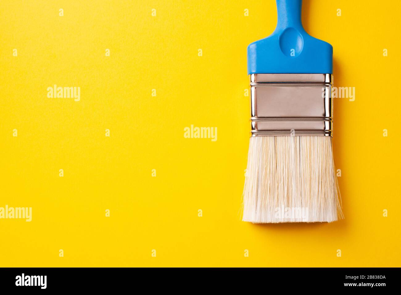 Brush on a yellow background, copy paste Stock Photo - Alamy