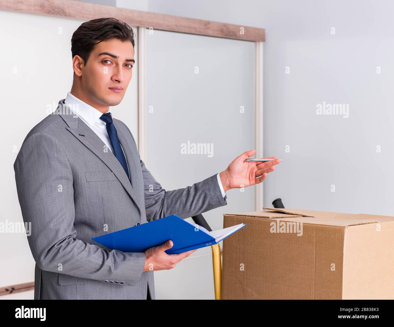 The man signing for the delivery of boxes Stock Photo - Alamy
