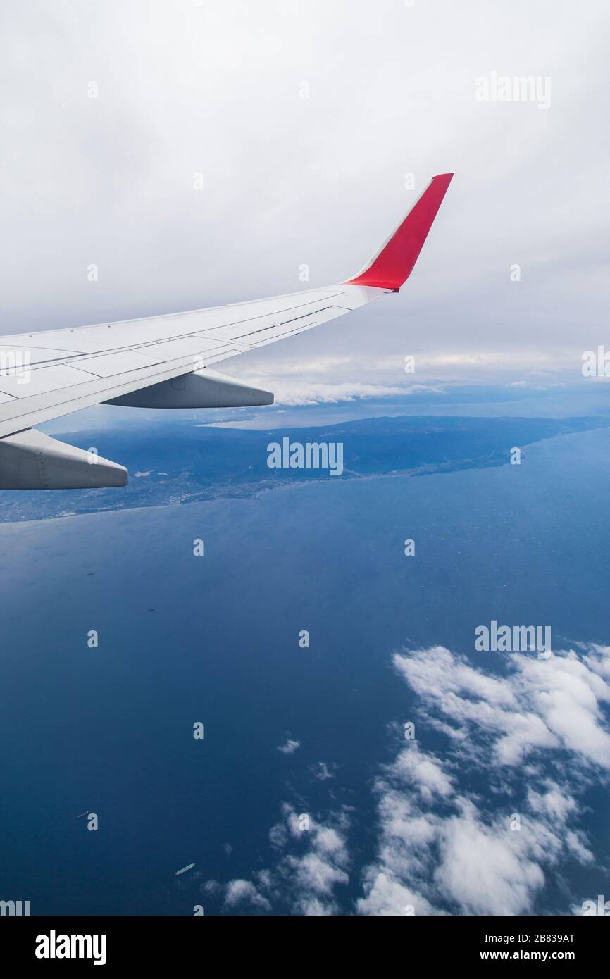 Empty airplane wing view via passenger window with blue sky, clean and ...