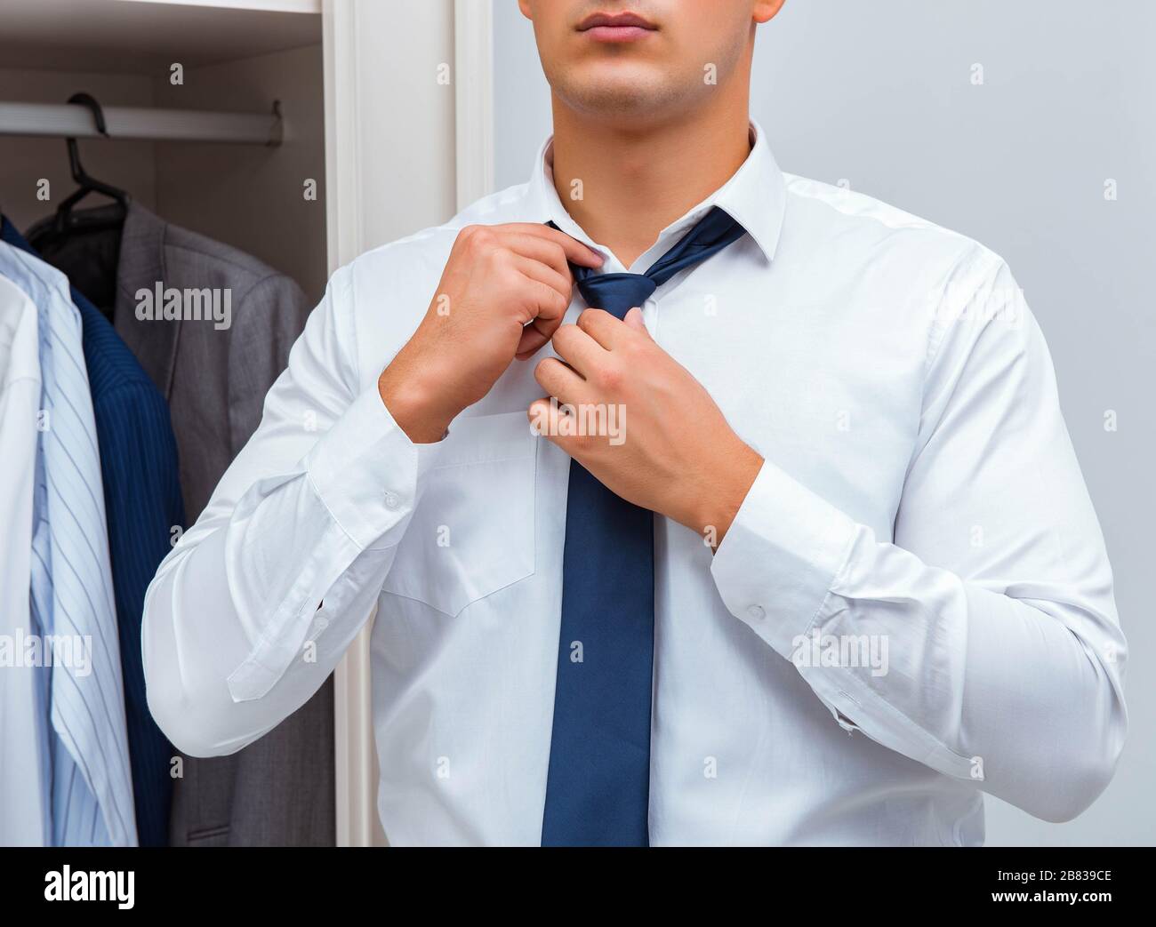The businessman dressing up for work Stock Photo - Alamy