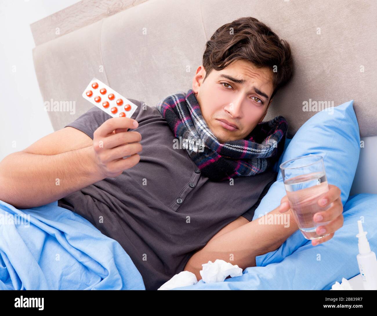 The sick ill man in the bed taking medicines and drugs Stock Photo - Alamy