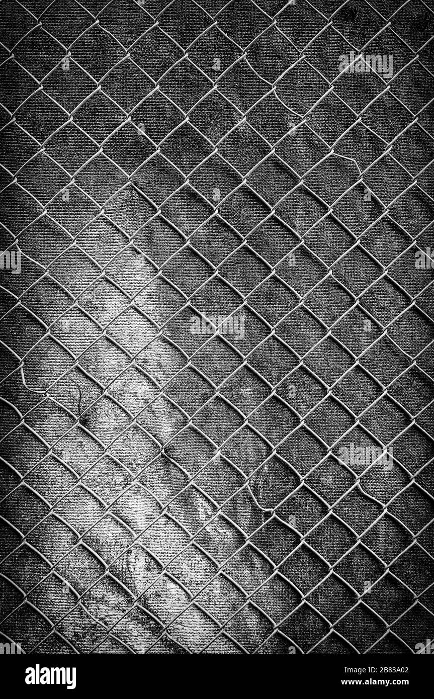 Metal grid on the wall, detail of a person protected by a metal wall ...