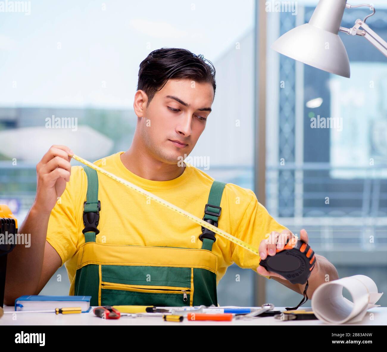 The construction worker sitting at the desk Stock Photo - Alamy
