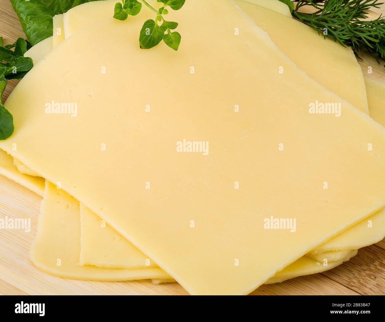 Thin sliced continental cheese with salad garnish Stock Photo - Alamy