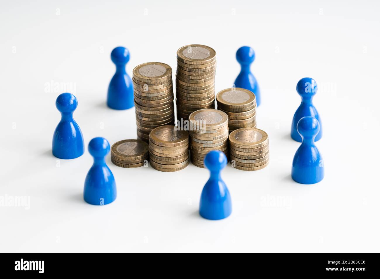 Close-up Of Coin Stack Surrounded With Blue Figures On White Background ...