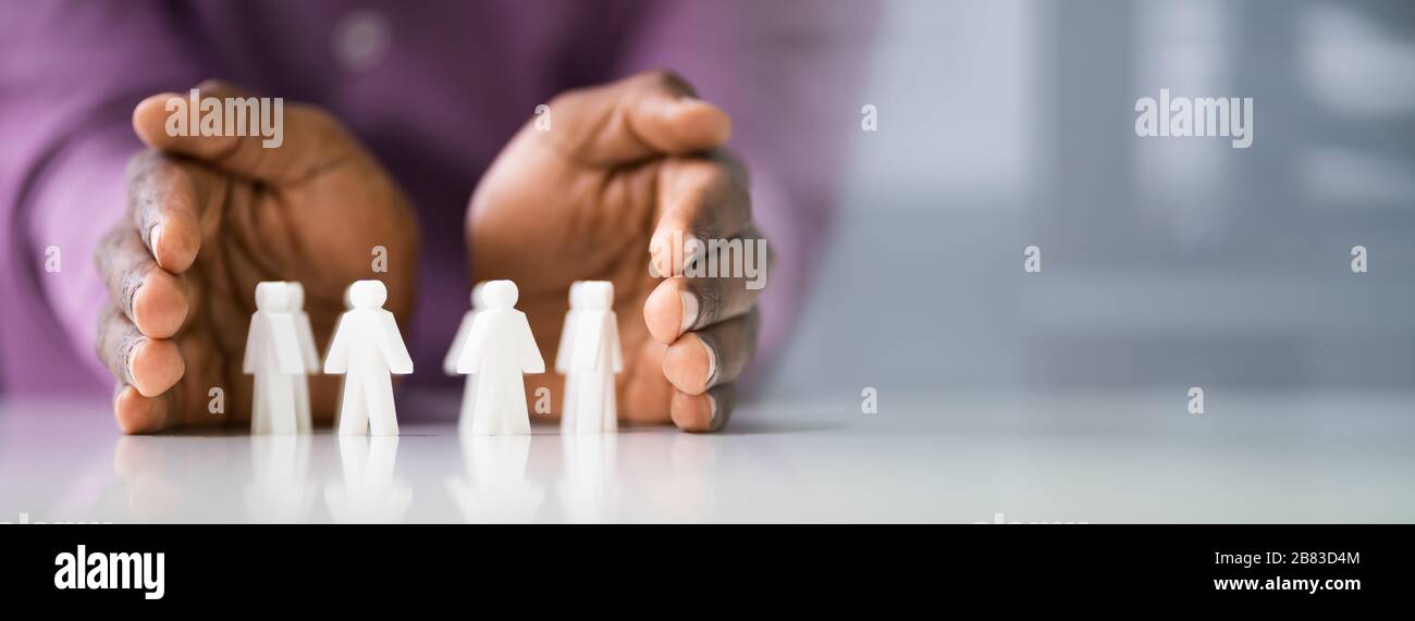 Close-up Of A Human Hand Protecting Red Human Figures On White ...