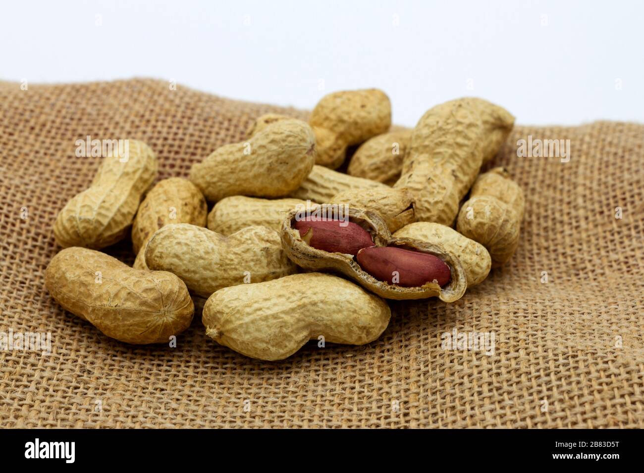 peeled and unpeeled peanuts on white background Stock Photo - Alamy