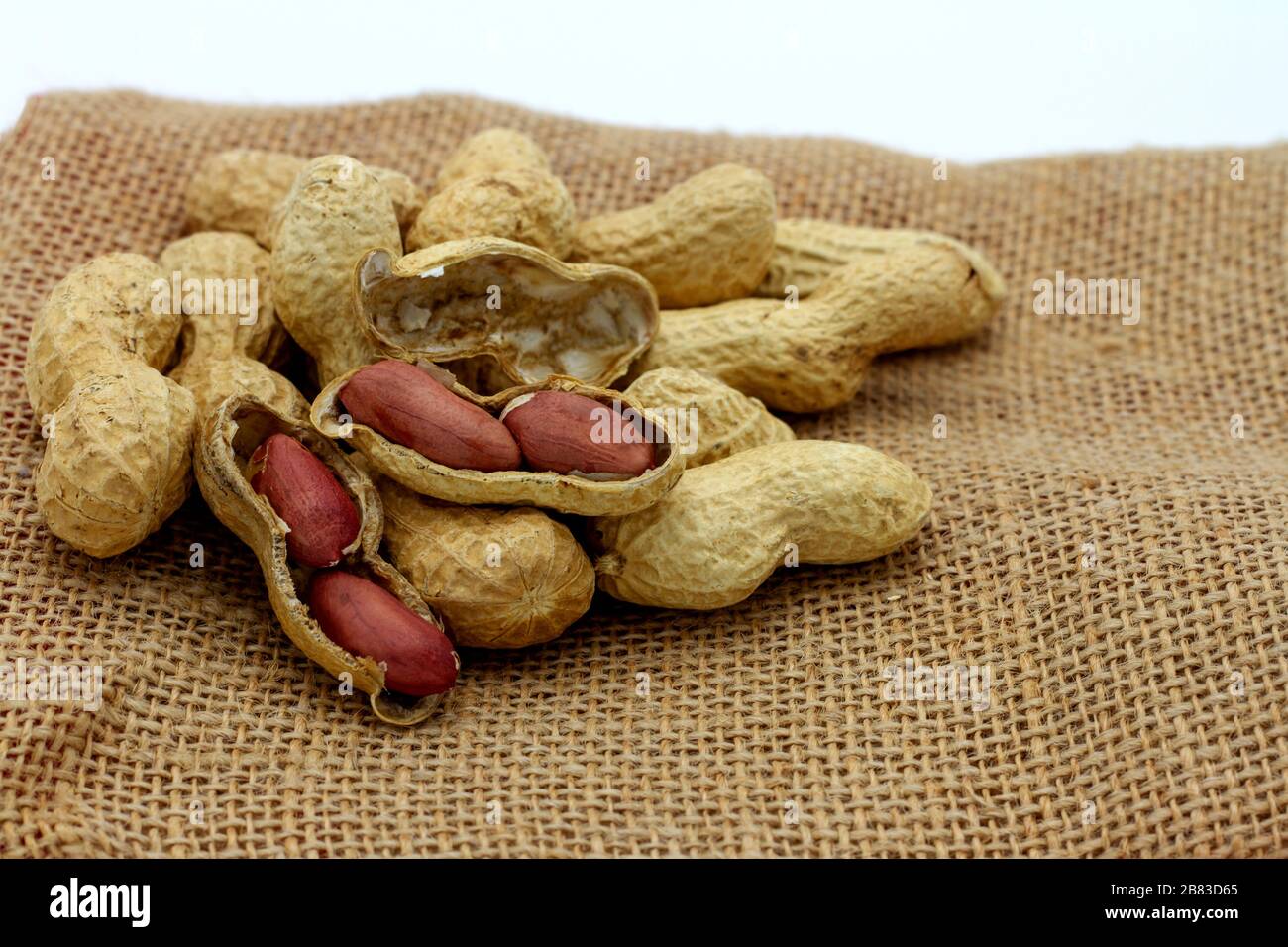 peeled and unpeeled peanuts on white background Stock Photo - Alamy