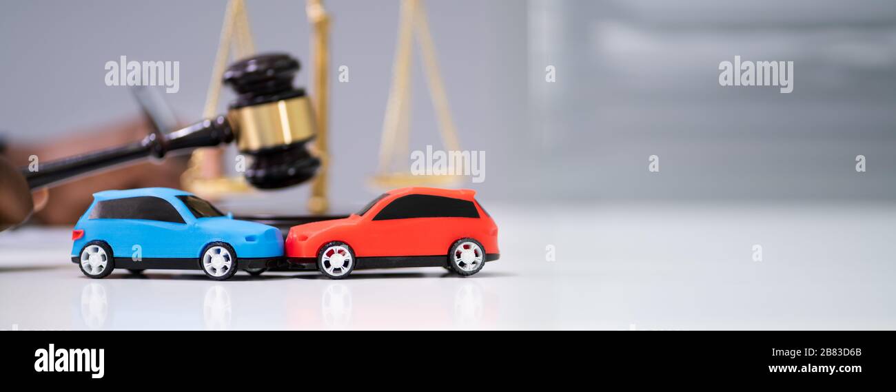 Two Cars In Front Of Gavel And Mallet And Judge Stock Photo - Alamy