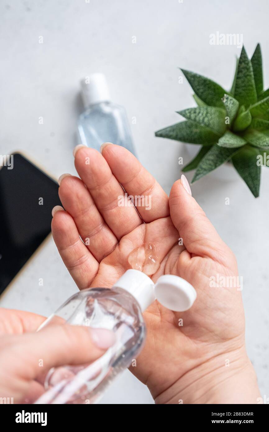 Hand cleaning gel. Pouring sanitising hand gel onto a woman hand Stock ...