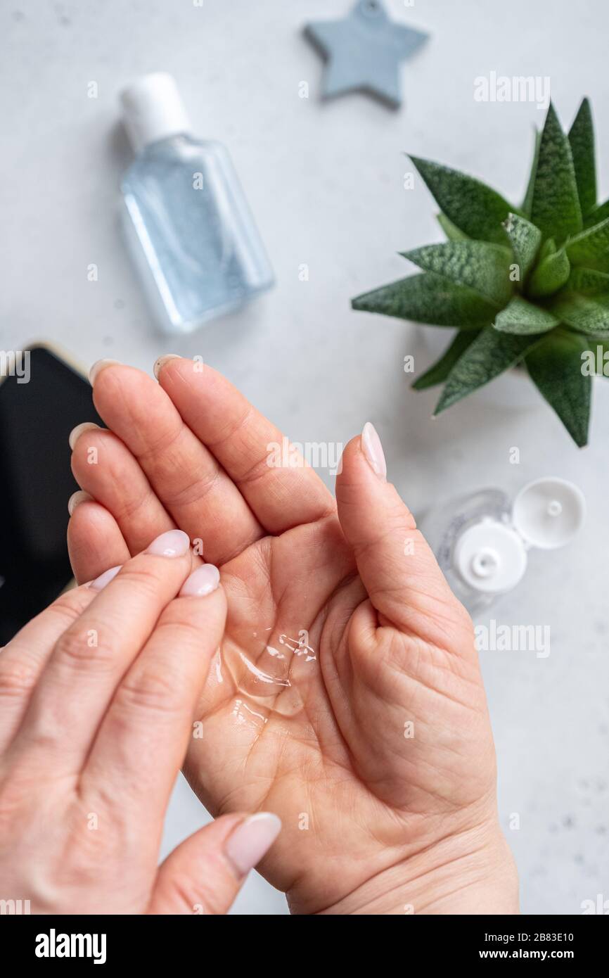 Hand cleaning gel. Pouring sanitising hand gel onto a woman hand Stock ...
