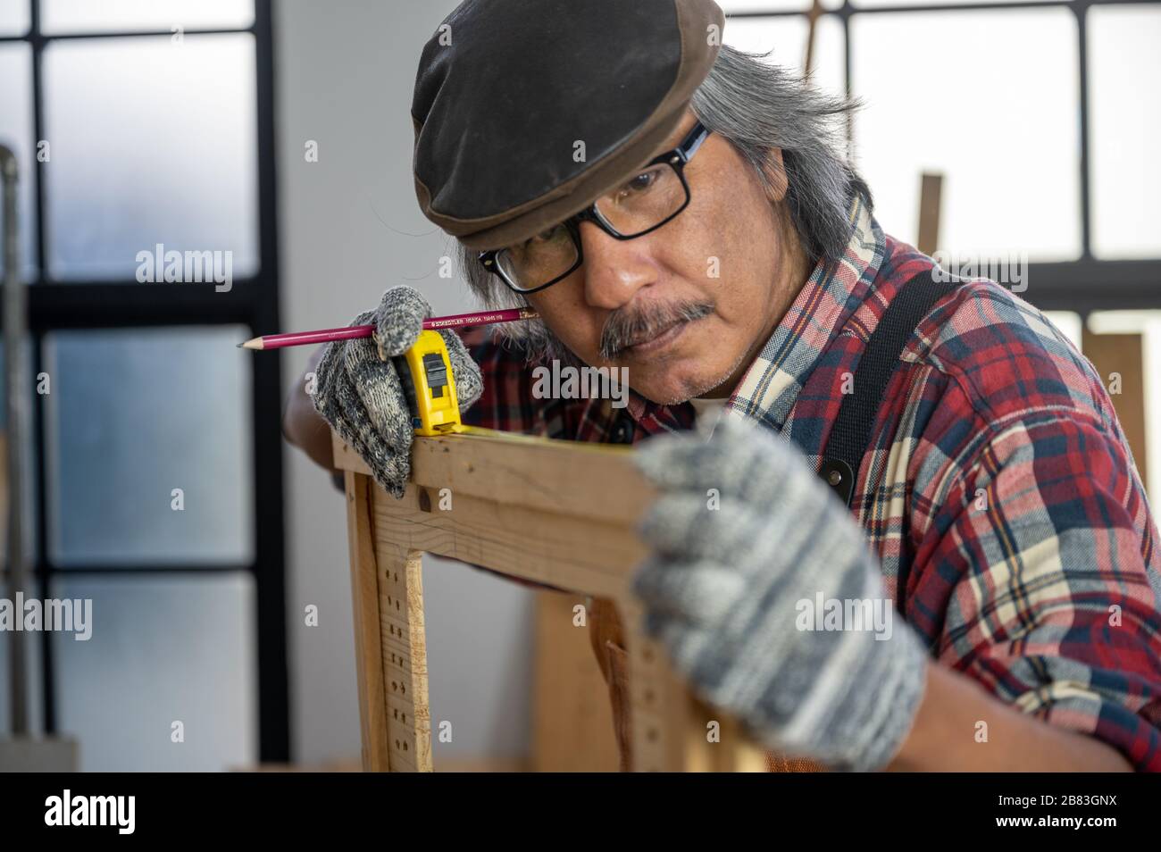 The carpenter is using the tools to work in the wooden studio Stock ...