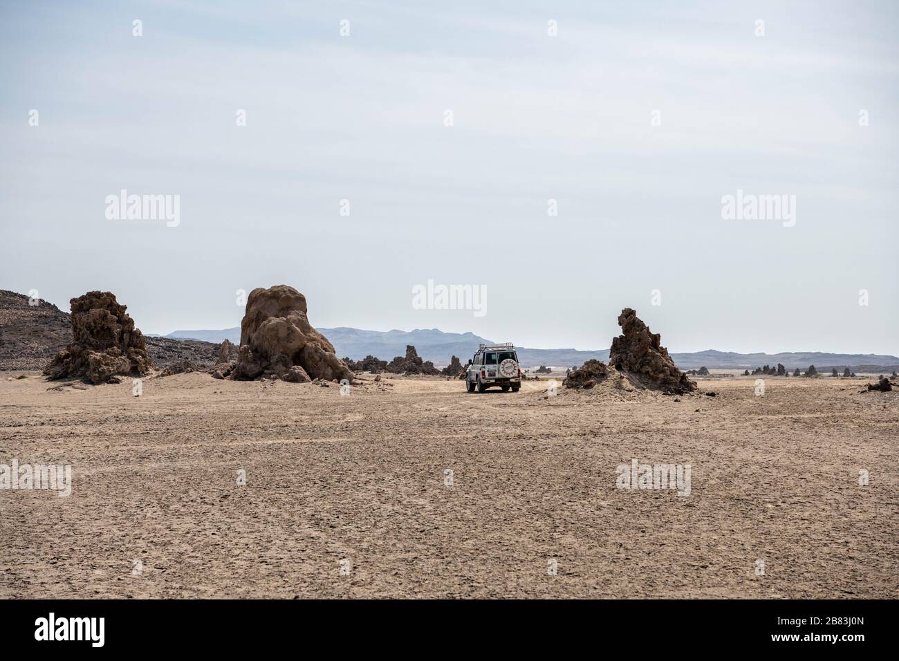 Africa, Djibouti, Lake Abbe. Landscape view of lake Abbe. An SUV is ...