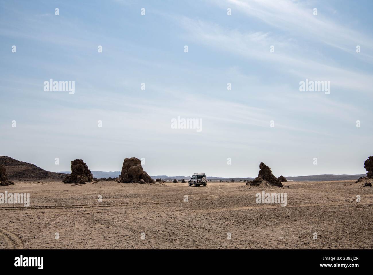 Africa, Djibouti, Lake Abbe. Landscape view of lake Abbe. An SUV is ...