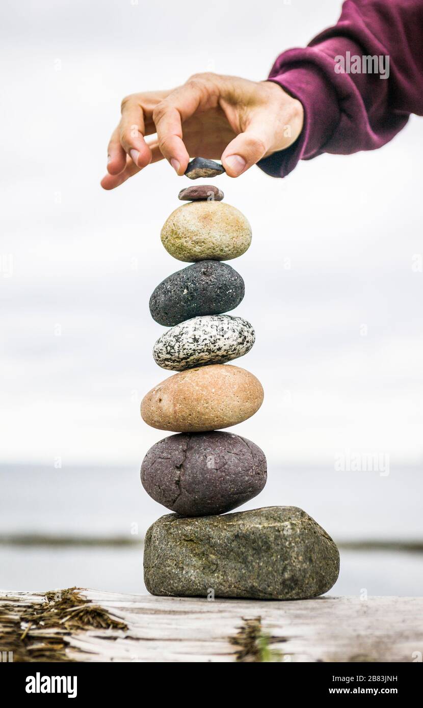 Hand stacking stones hi-res stock photography and images - Alamy