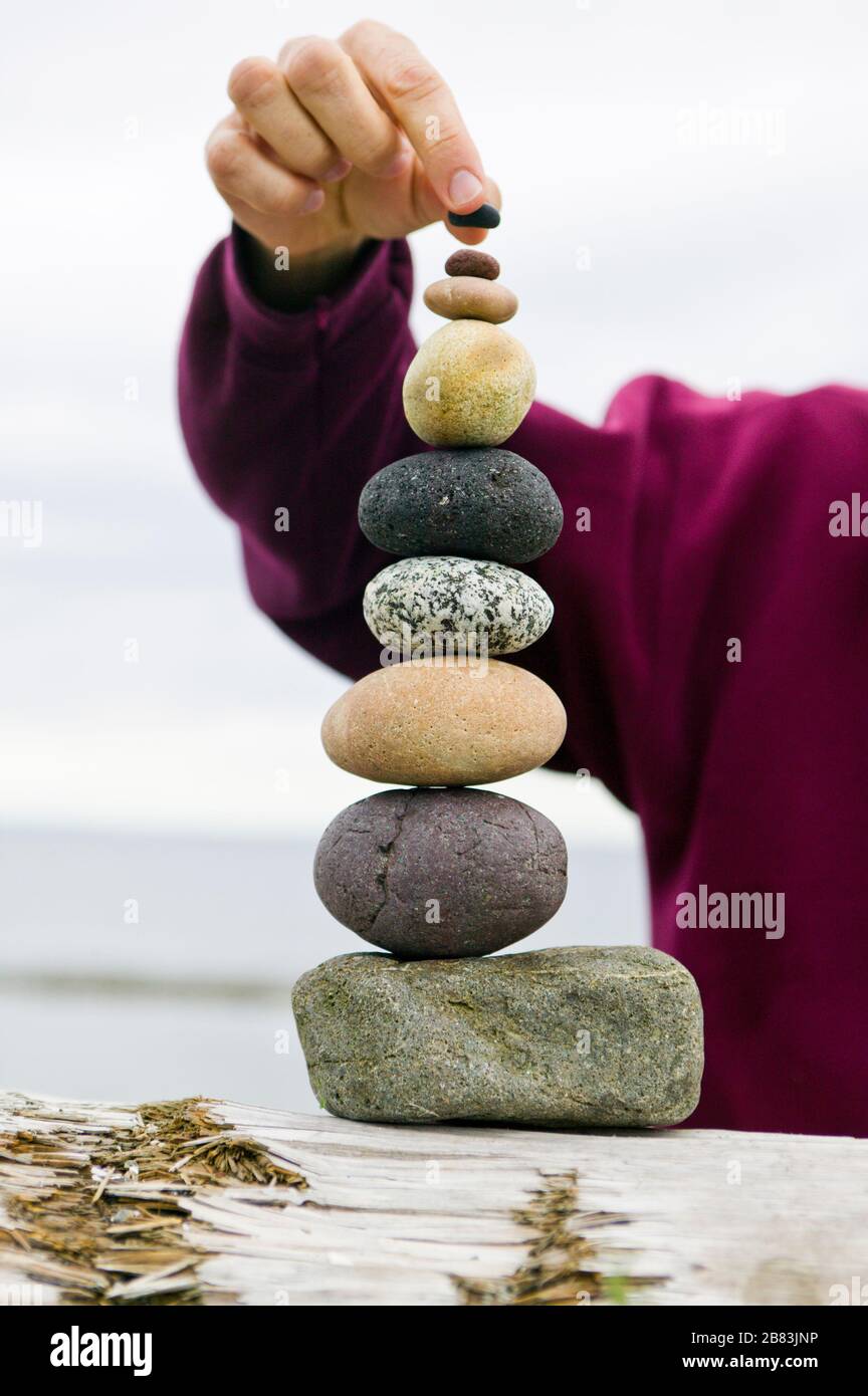 A man balancing rocks on top of one another Stock Photo - Alamy