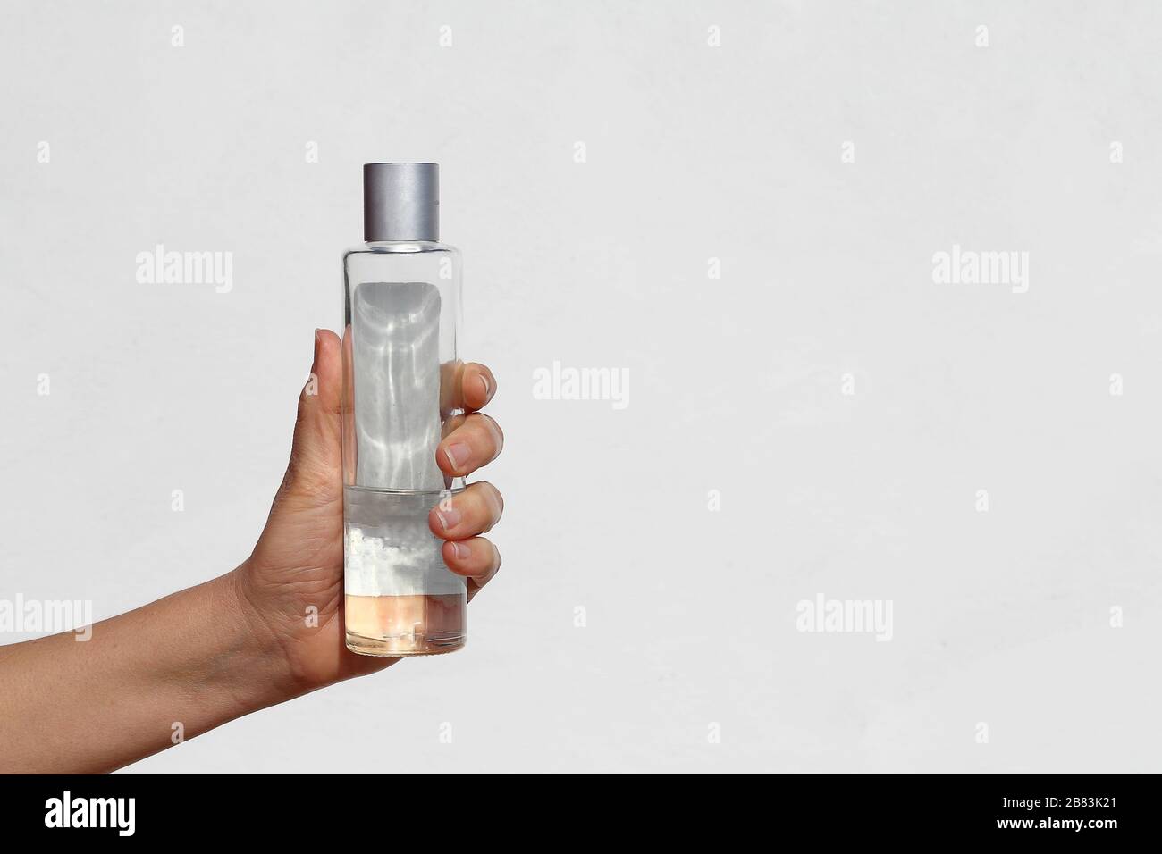 Hand with cologne isolated on white background Stock Photo - Alamy