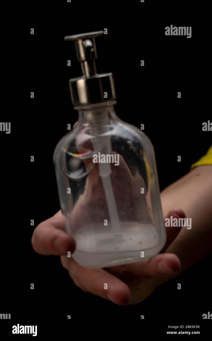 Young man is holding taking giving throwing a soap bottle for washing ...