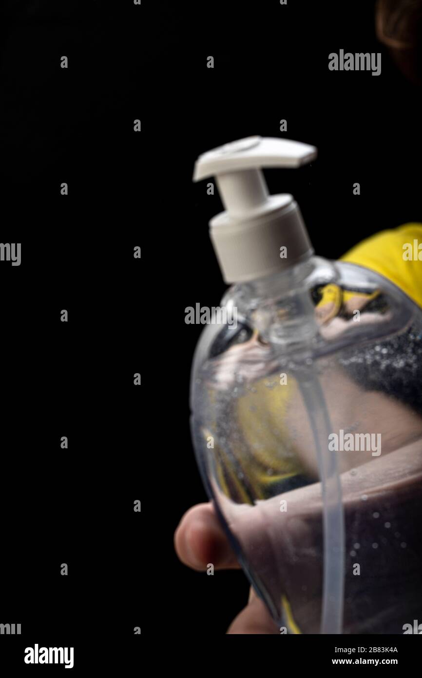 Young man is holding taking giving throwing a soap bottle for washing ...