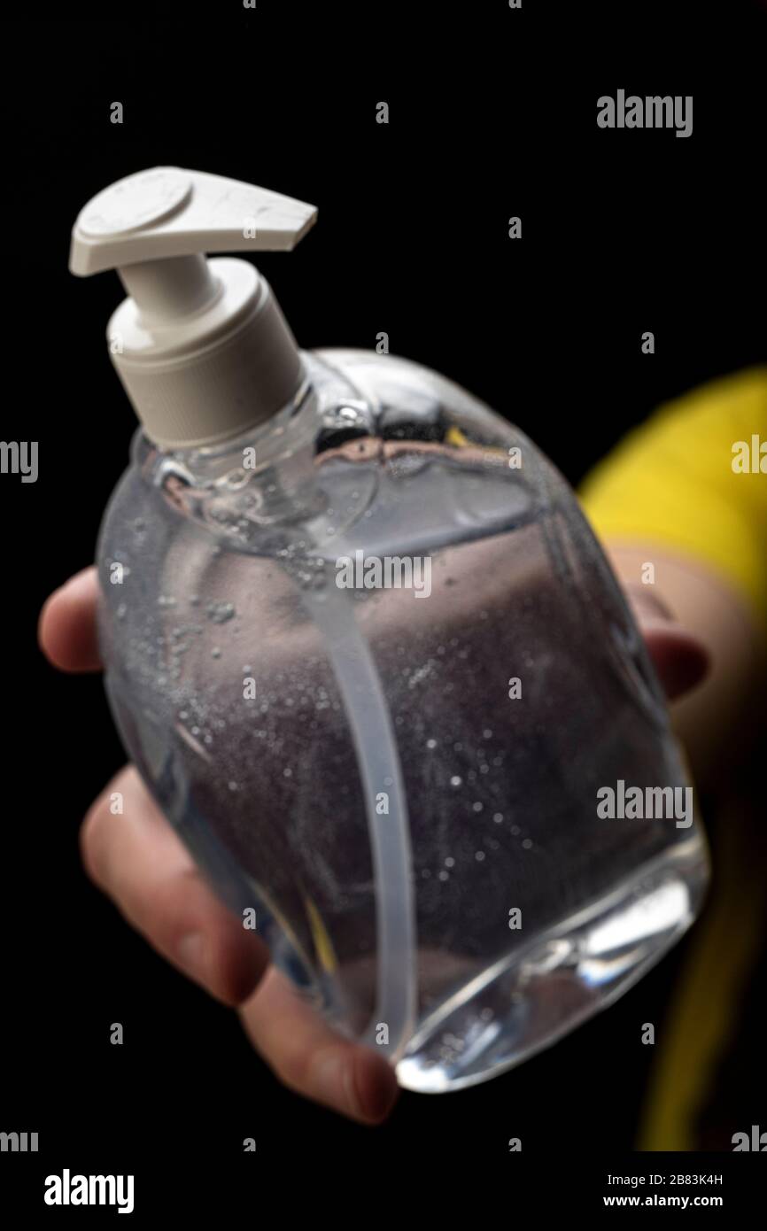 Young man is holding taking giving throwing a soap bottle for washing ...
