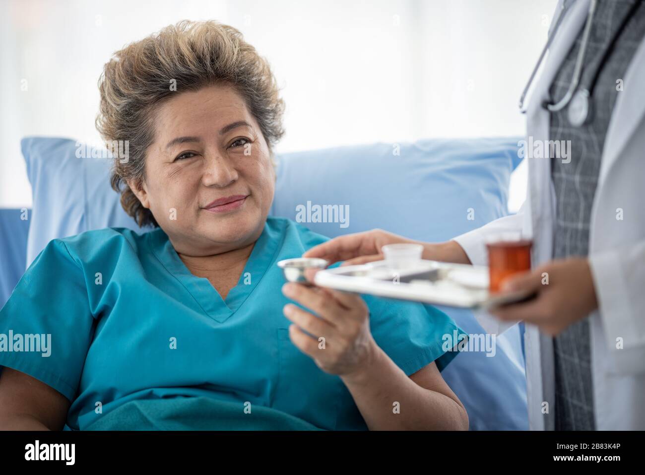 doctor making sure her patient taking medication Stock Photo - Alamy