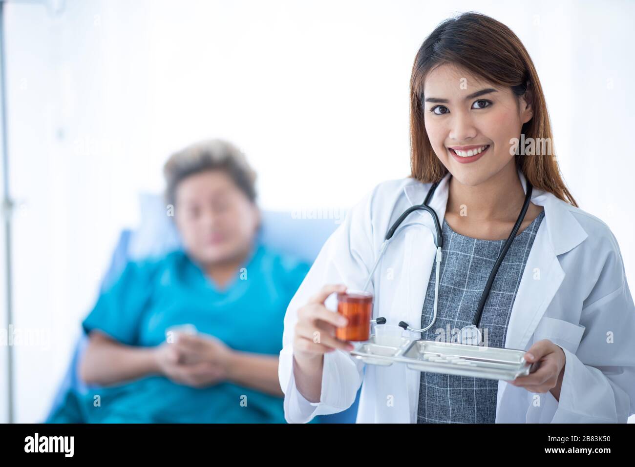 doctor making sure her patient taking medication Stock Photo - Alamy