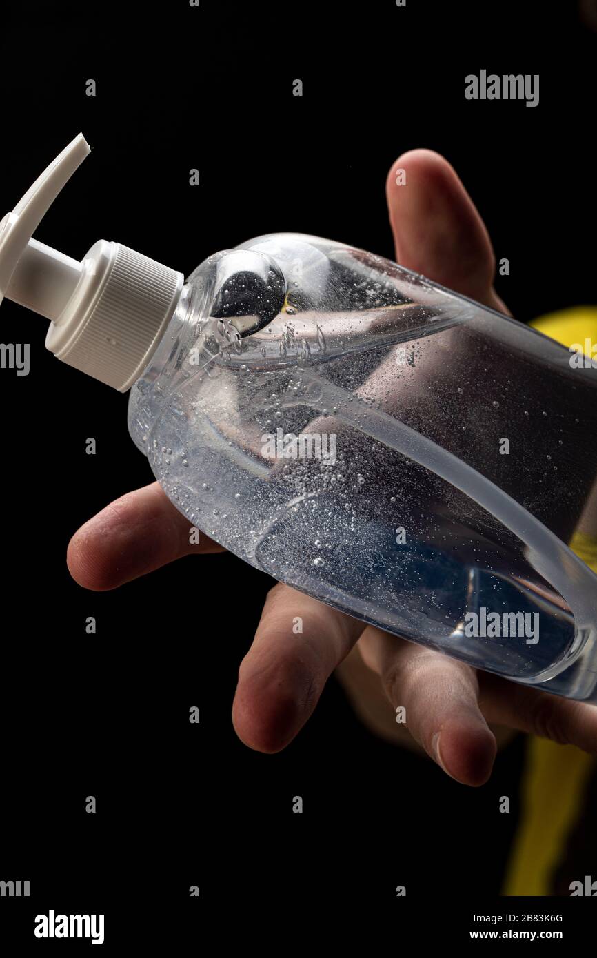 Young man is holding taking giving throwing a soap bottle for washing ...