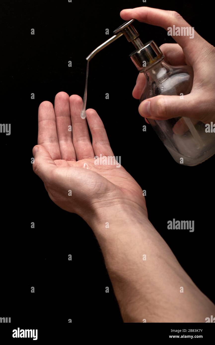 Young man is holding taking giving throwing a soap bottle for washing ...