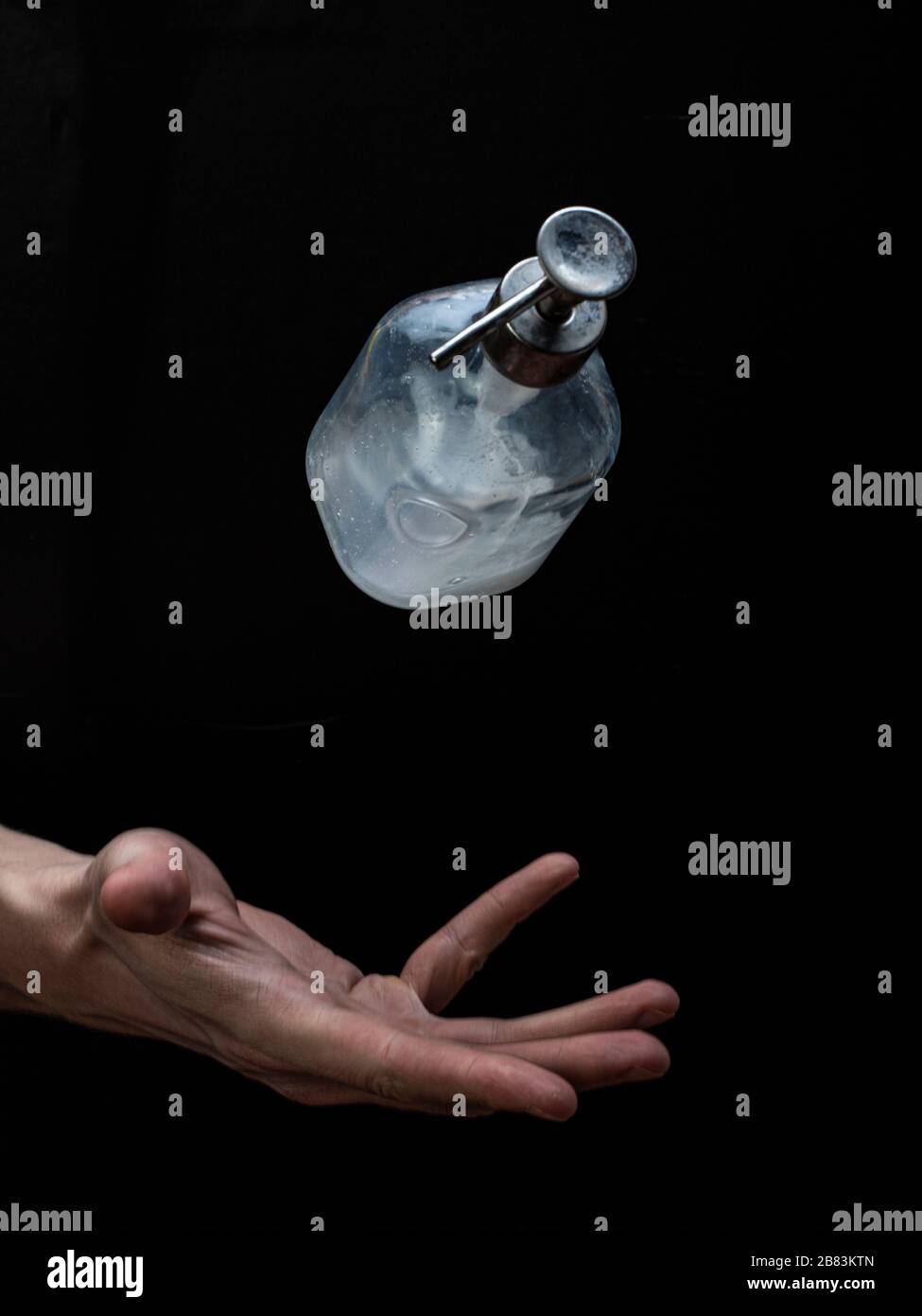 Young man is holding taking giving throwing a soap bottle for washing ...