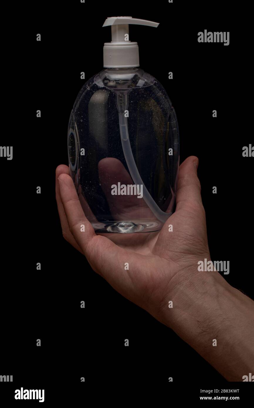 Young man is holding taking giving throwing a soap bottle for washing ...