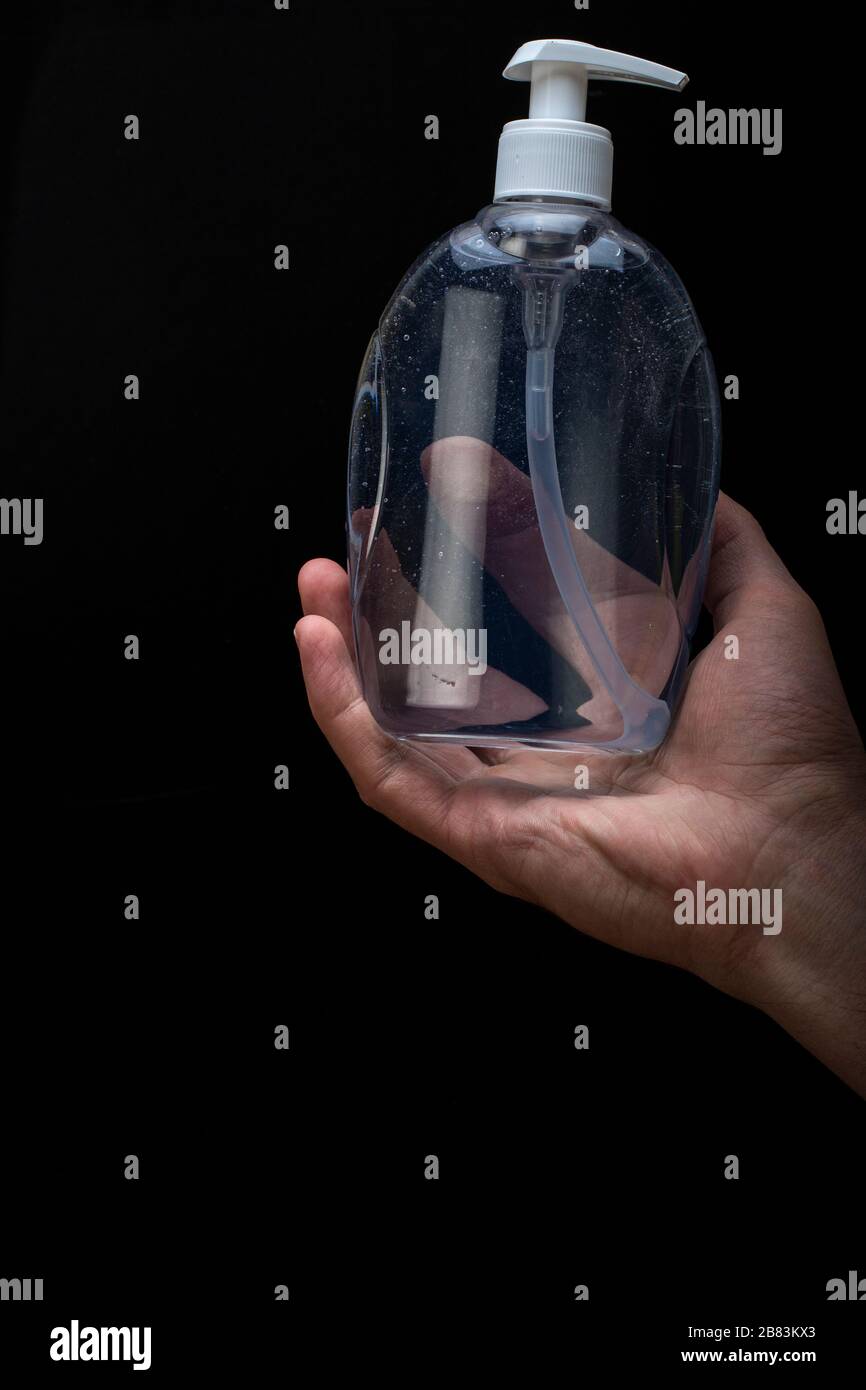 Young man is holding taking giving throwing a soap bottle for washing ...