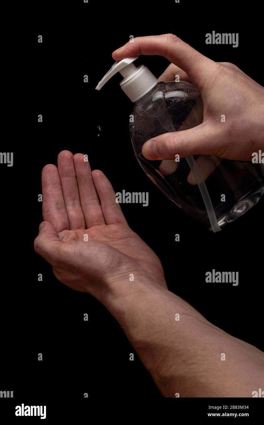 Young man is holding taking giving throwing a soap bottle for washing ...