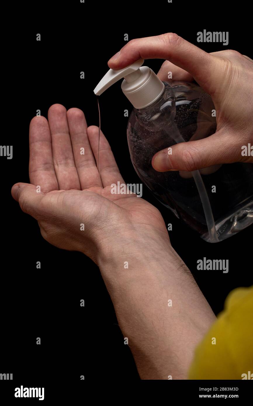 Young man is holding taking giving throwing a soap bottle for washing ...