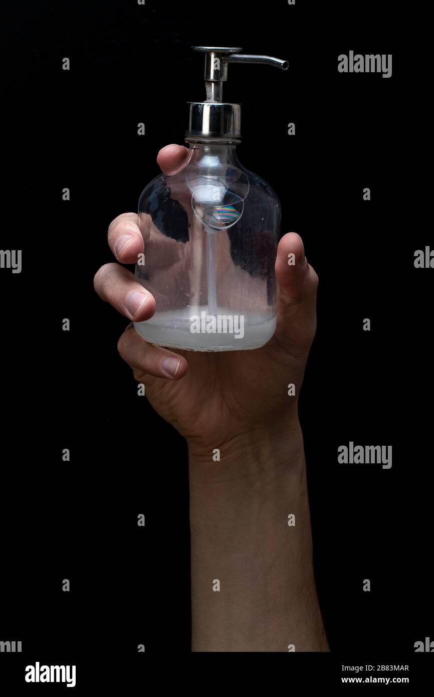 Young man is holding taking giving throwing a soap bottle for washing ...