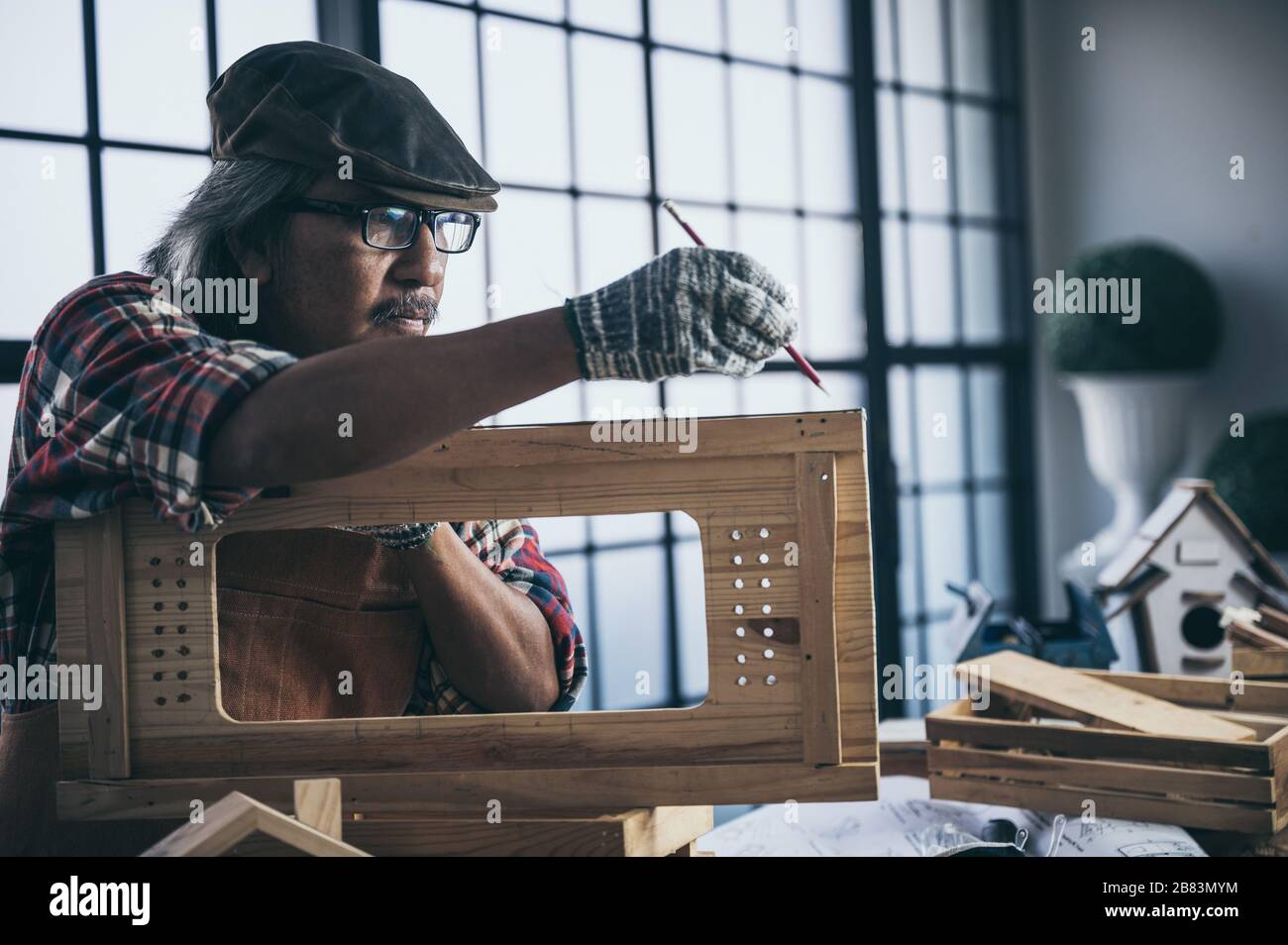 A carpenter is designing and working on hand-made wood Stock Photo - Alamy