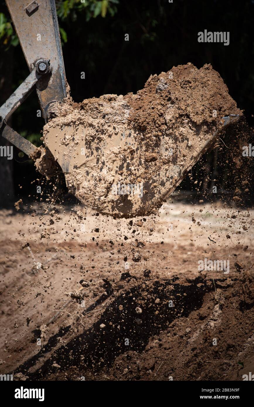 Excavator working with soil and water, during earthmoving works Stock ...