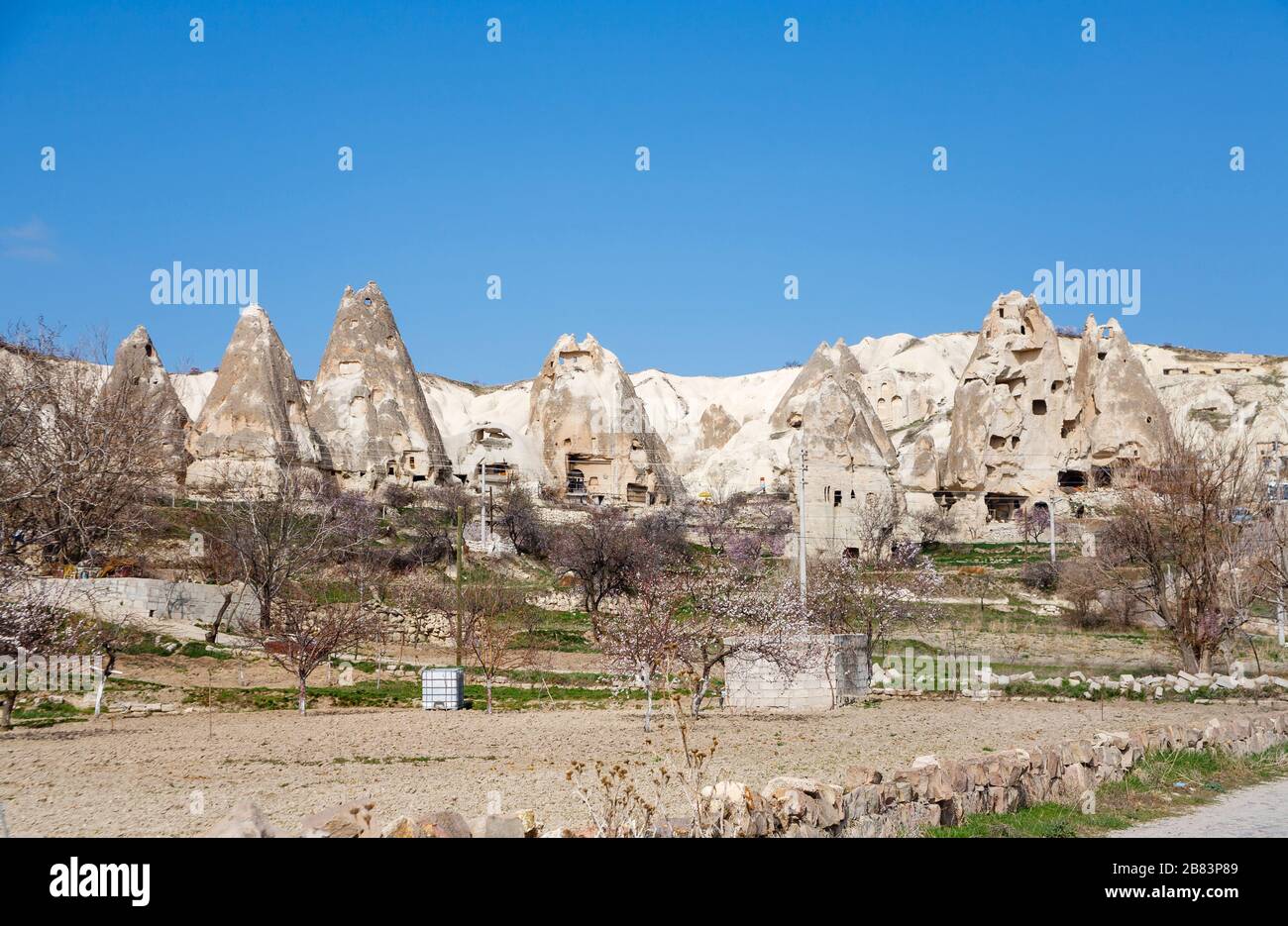 Fairy chimney rock formation with caves and remains of troglodyte ...