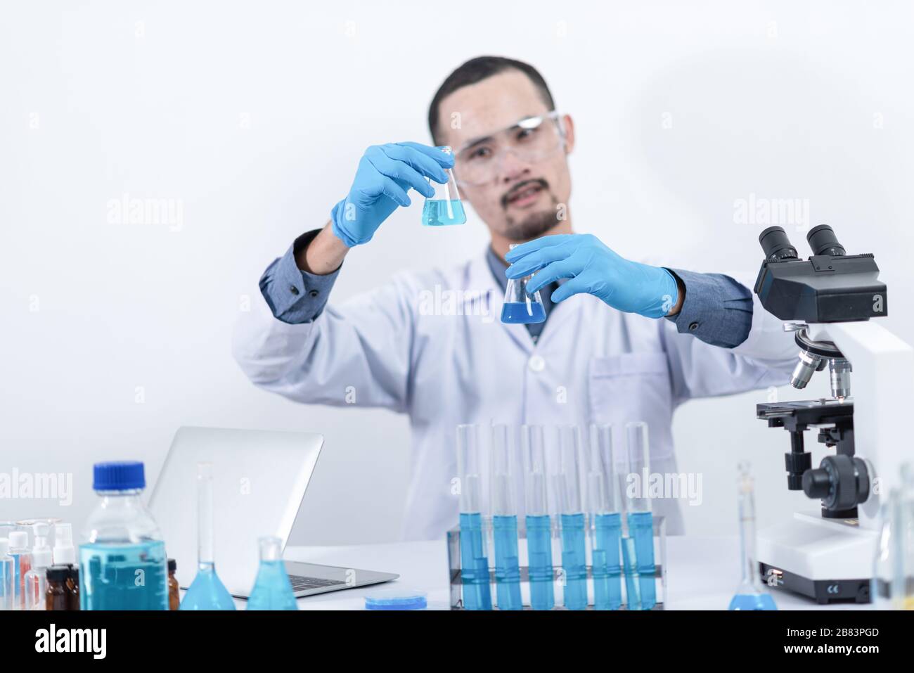 Researcher in the laboratory Studying with chemicals And microscopes ...