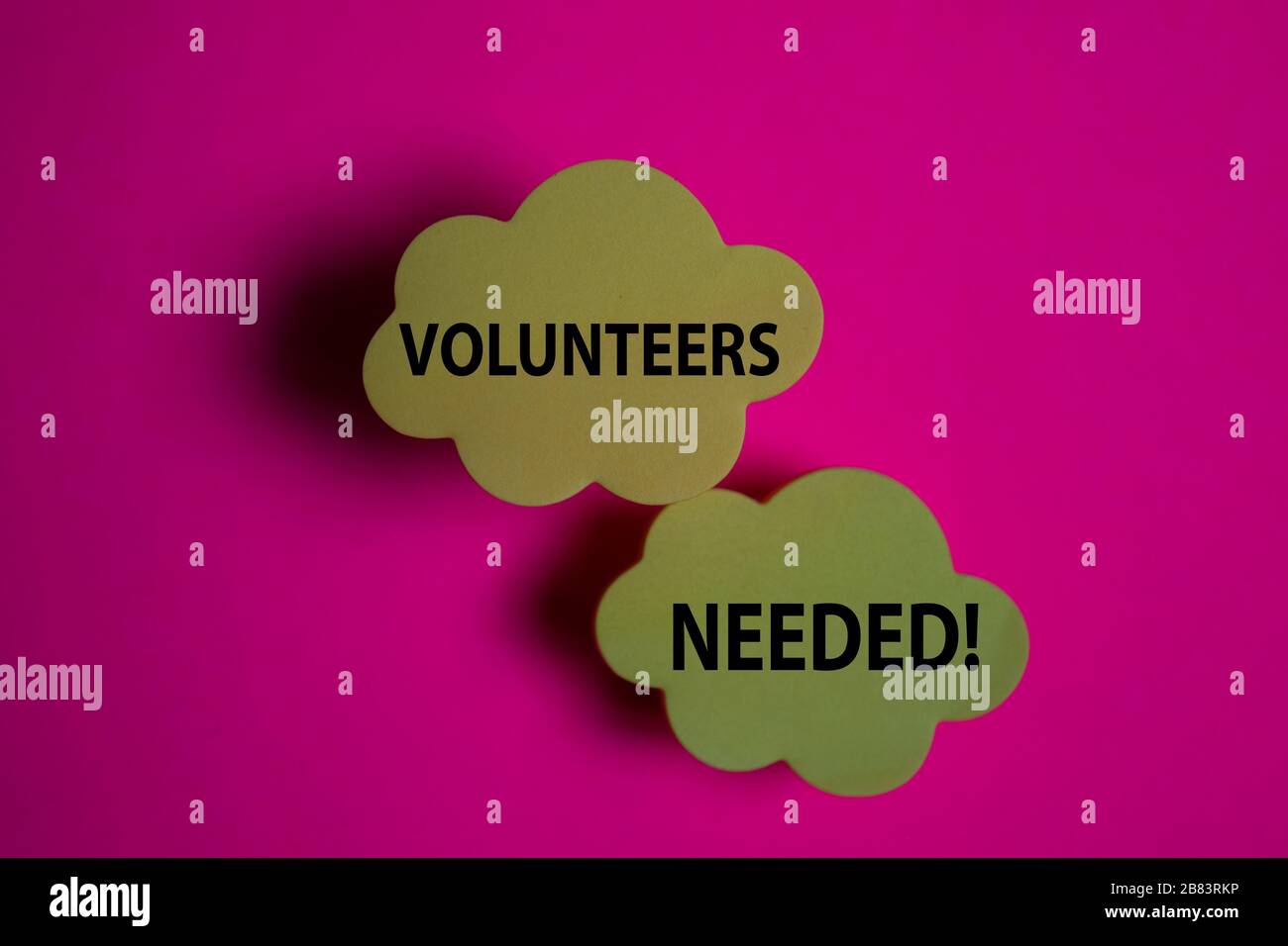 Volunteers Needed! write on a sticky note isolated on Office Desk Stock ...