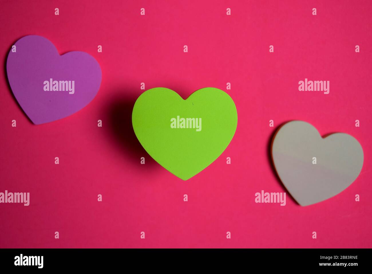 sticky note shaped a heart symbol on pink background Stock Photo - Alamy
