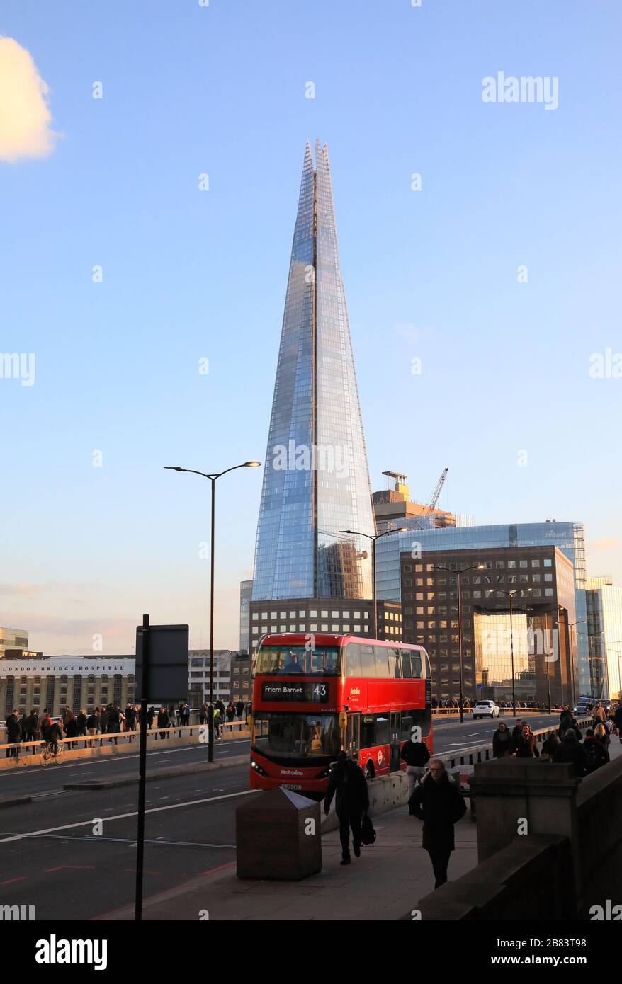 View across London Bridge towards the Shard at rush hour in winter, in ...