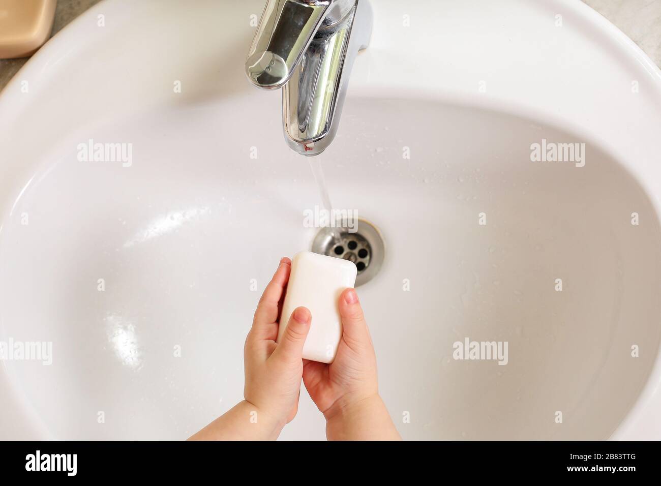 Child washing hands with soap under the tap with water Stock Photo - Alamy