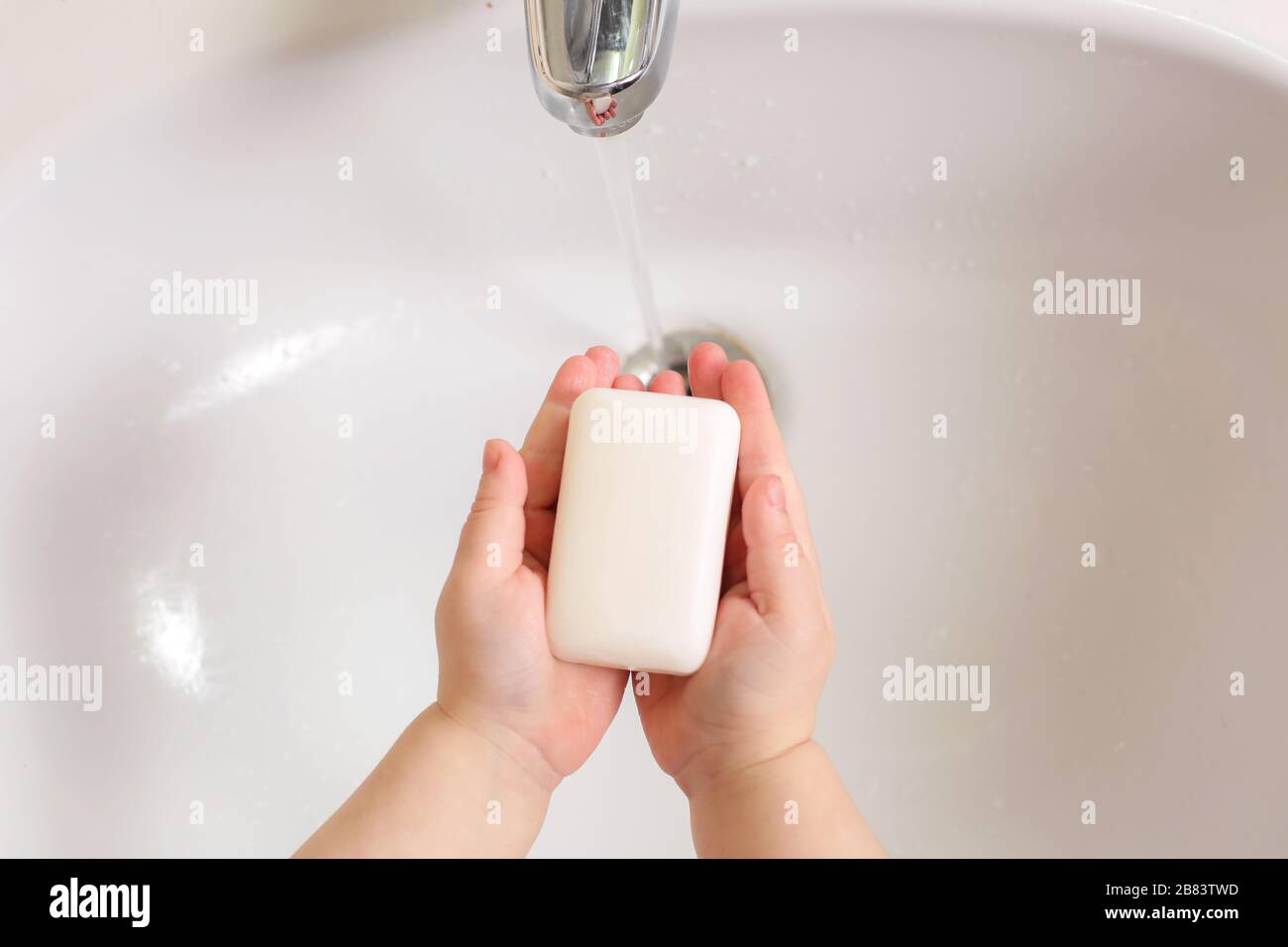 Child washing hands with soap under the tap with water Stock Photo - Alamy