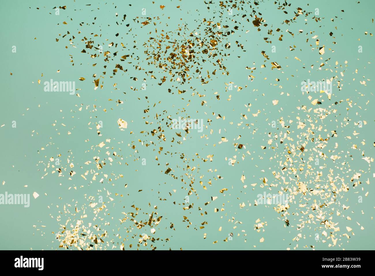 Golden flying sparkles on blue holiday background. Festive backdrop for ...