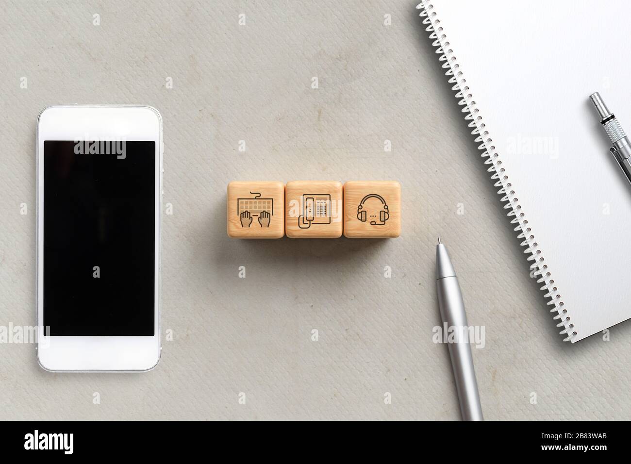 cubes with icons symbolizing a call center surrounded by a smartphone ...