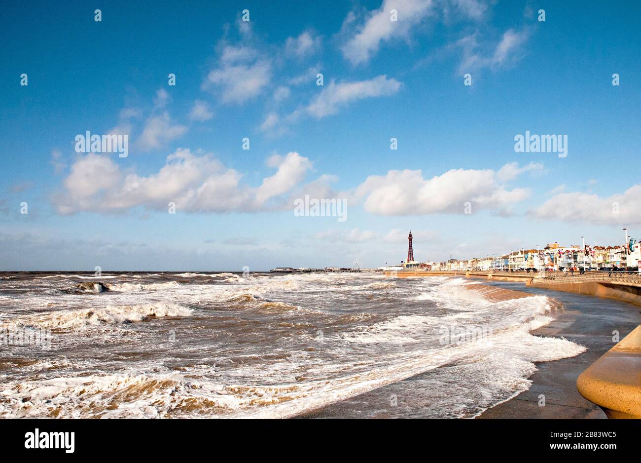 View of waves coming in at high tide and curve of the new sea wall with ...
